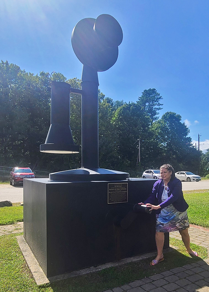 This woman demonstrates the proper technique for pretending to make a call on a telephone taller than most basketball players.