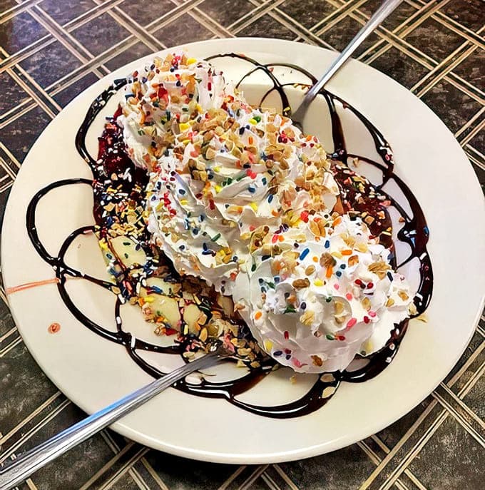 The sign stands as a beacon to hungry travelers &ndash; a roadside promise of honest food that satisfies both stomach and soul.