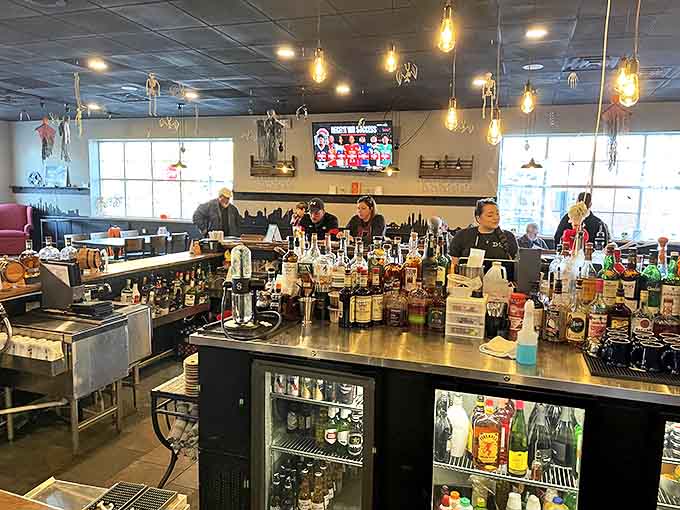 The bar at District 13 isn't just about drinks &ndash; it's a showcase of craftsmanship where mixologists work their magic among an impressive bottle collection.