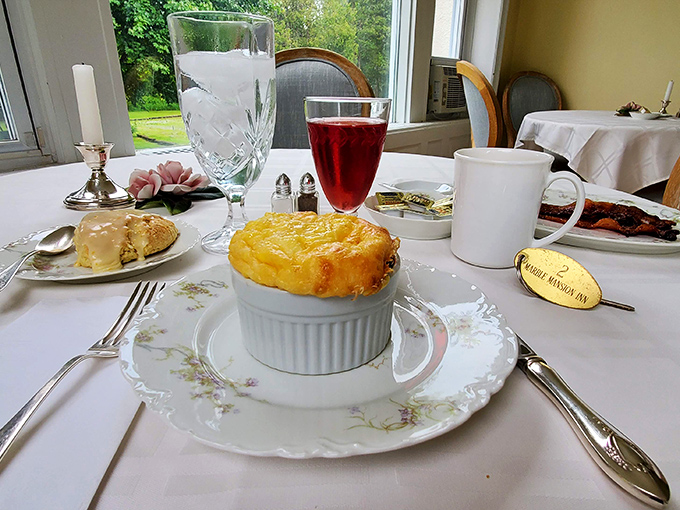 A perfectly puffed cheese souffl&eacute; sits like edible architecture, waiting to collapse deliciously at the touch of a fork.