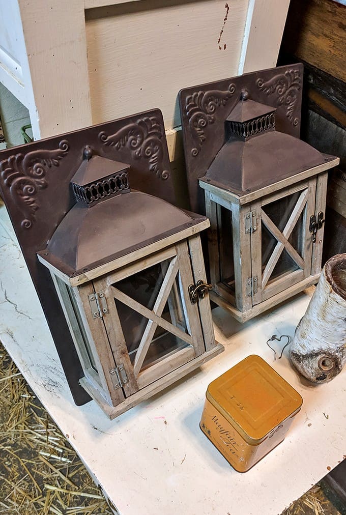 Rustic wooden lanterns with copper accents offer both vintage appeal and modern functionality &ndash; their weathered finish telling stories of times past.