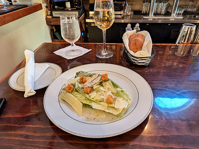 A perfectly executed Caesar salad arrives with crisp romaine, house-made dressing, and shavings of aged Parmesan &ndash; simple ingredients elevated through attention to detail.