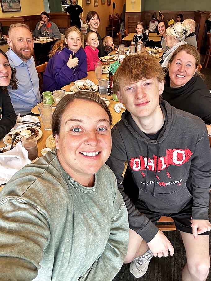 The courtyard fills with diners enjoying Arnold's hospitality, where conversations flow as freely as the drinks under the colorful string lights.