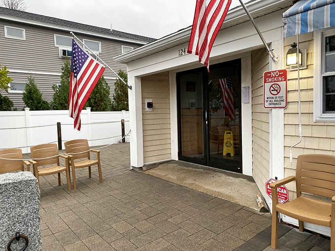 American flags flutter at the entrance, welcoming hungry travelers. Those outdoor chairs have witnessed countless "I'm too full to move" moments.