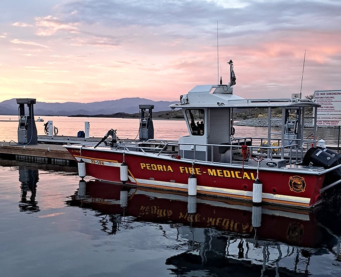 Sunset casts a golden glow over Lake Pleasant as the Peoria Fire-Medical boat stands ready for safety.