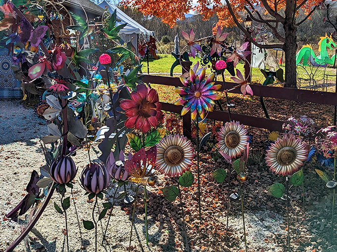 Metal flowers bloom eternally along rustic fences &ndash; garden art that celebrates nature's beauty while defying its seasons.