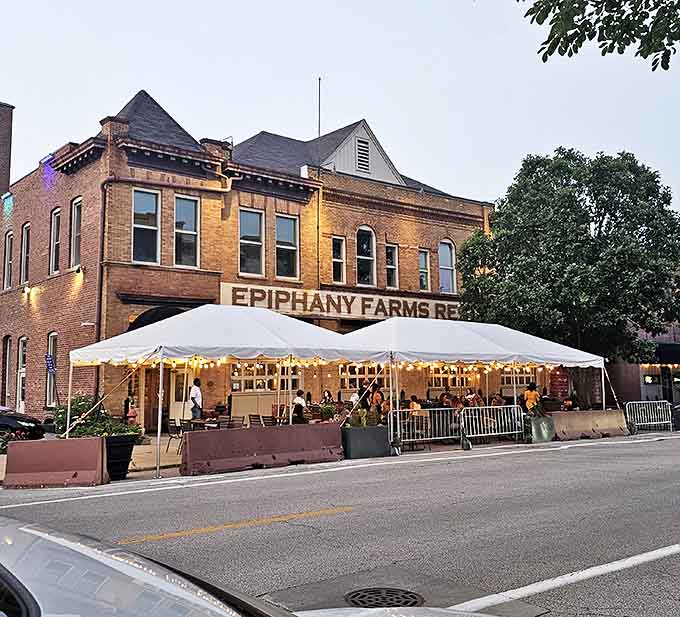 Evening transforms Epiphany Farms into a glowing beacon of culinary delight. The tent extends the magic outdoors when weather permits.