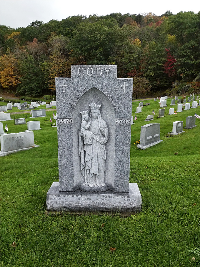 The Cody family monument features exquisite carved detail, a testament to both faith and the Vermont tradition of exceptional stonework.