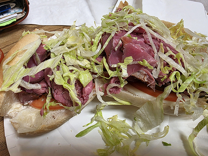 Fresh lettuce adds crisp contrast to tender roast beef, creating that perfect textural interplay that elevates a simple sandwich to art form.