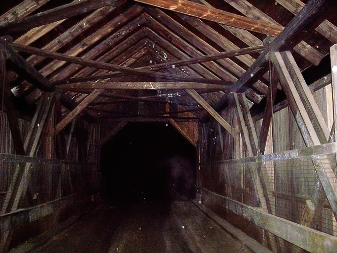 Inside the bridge at night, darkness gathers in corners and between beams, creating the perfect setting for imagination&mdash;or apparitions&mdash;to run wild.