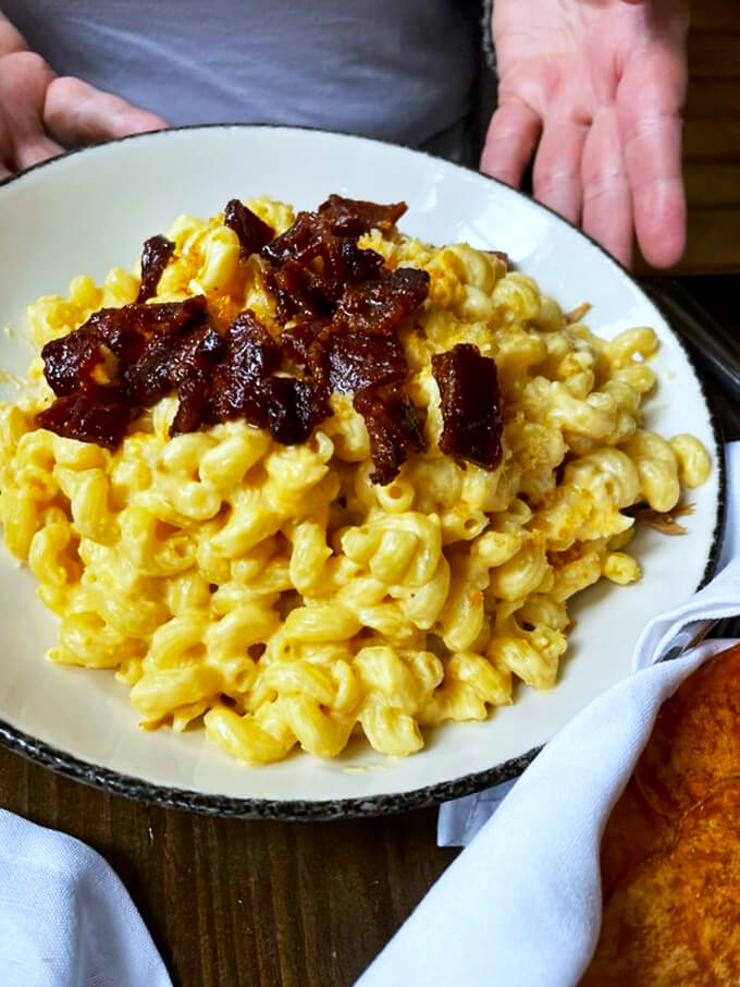 Mac and cheese that's cheesier than your uncle's jokes at Thanksgiving. Those crispy bacon bits are the cherry on top!