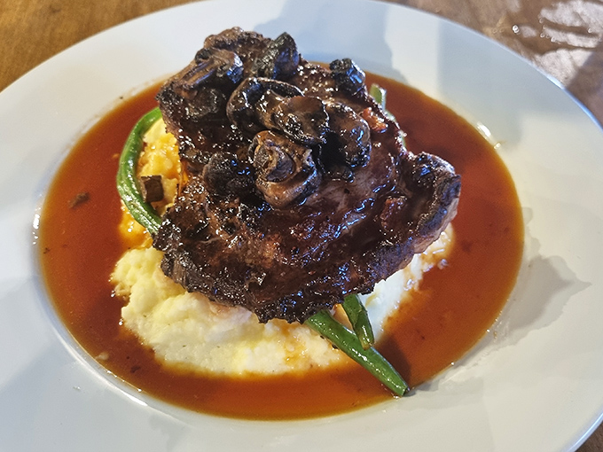 Fall-off-the-bone tender meat swimming in rich, savory gravy atop creamy mashed potatoes &ndash; comfort food elevated to an art form.