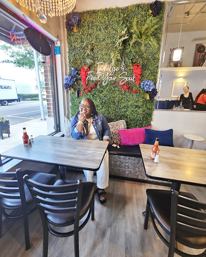 The signature green wall with neon "Indulge & Feed Your Soul" sign creates the perfect backdrop for both your meal and your inevitable social media moment.