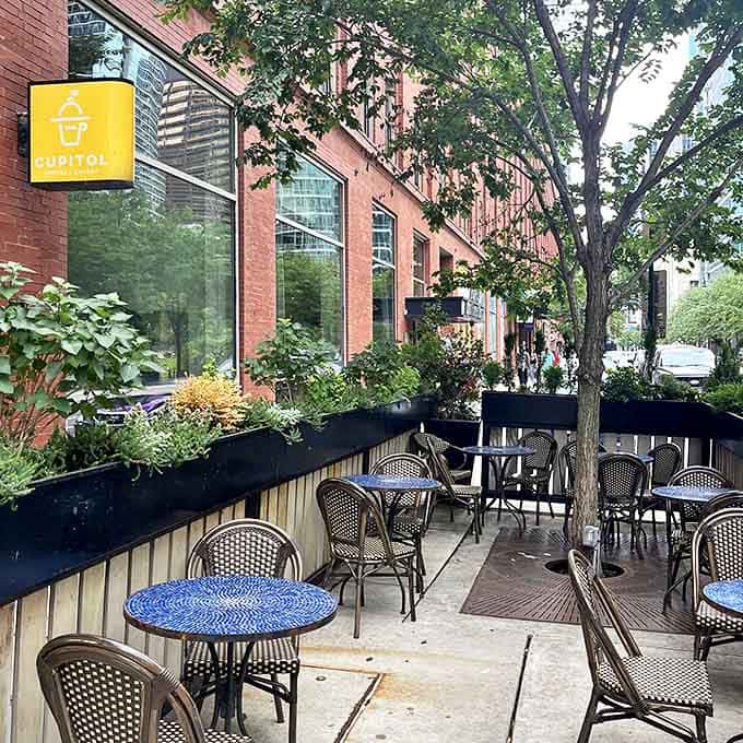 The outdoor patio offers urban tranquility, where coffee meets fresh air and conversation flows as freely as the espresso.