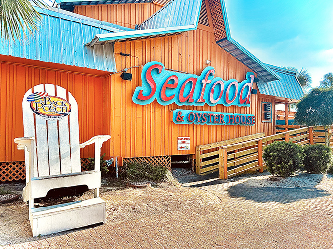 The restaurant's cheerful orange exterior stands out against the Florida sky, beckoning hungry beachgoers with promises of seafood and spectacular views.