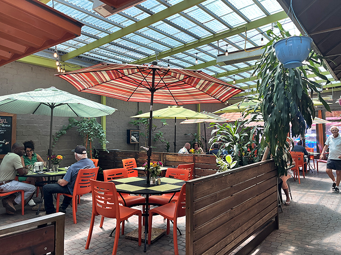 The covered patio creates an urban oasis, where colorful umbrellas and wooden dividers offer semi-private dining amid the bustle of Main Street.