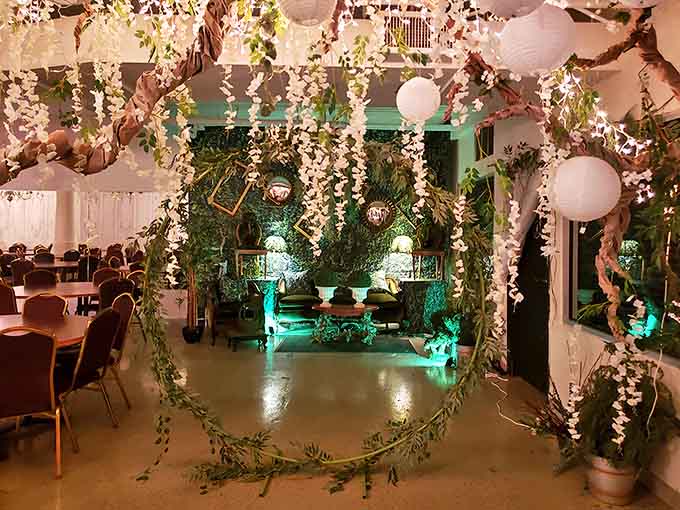 Step into an ethereal dreamscape where cascading white blossoms and soft green lighting transport visitors to a secret fairy garden.