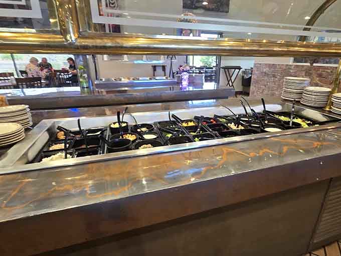 The buffet area gleams with organization and cleanliness, inviting diners to explore the various options available during service hours.