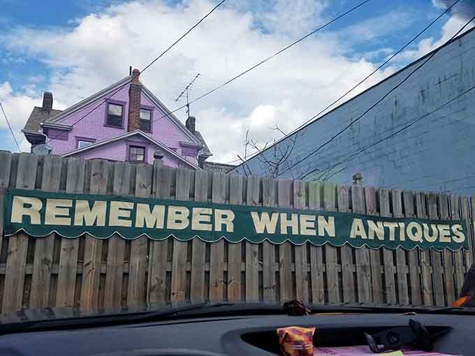 The purple Victorian transforms into a magical lantern at night, its illuminated windows promising warmth and wonders within.