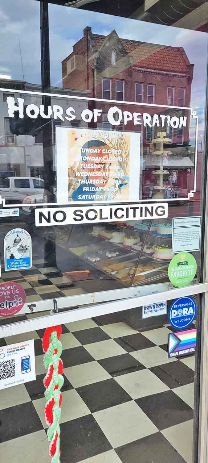 Hours of operation posted on the door &ndash; crucial information for planning your sugar fix and avoiding the heartbreak of arriving to find closed doors.