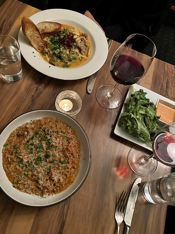 A table spread that tells stories: risotto whispering of patience, pasta speaking of tradition, and wine translating it all.