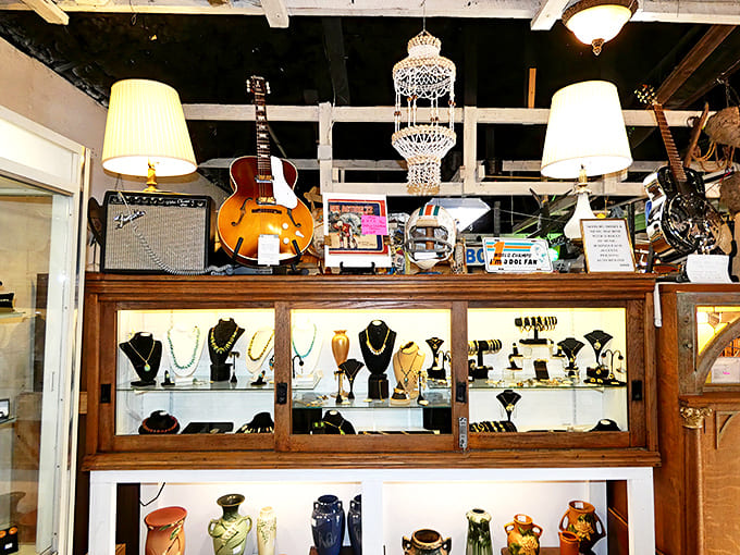 A collector's paradise where jewelry, instruments, and decorative arts coexist in beautiful chaos. That guitar might have played its first chord during the Kennedy administration!