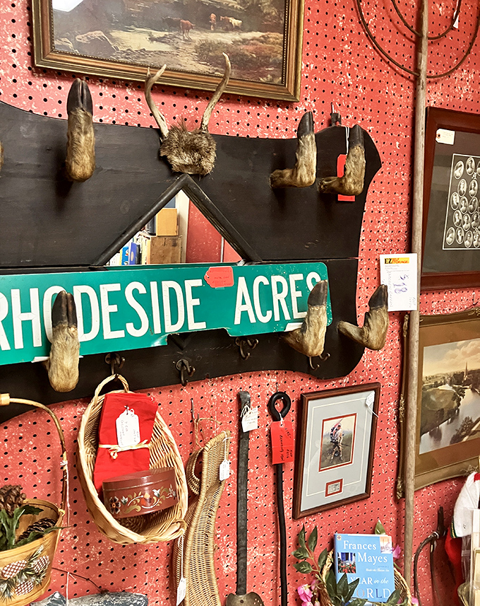 "Rhodeside Acres" sign with various animal feet &ndash; because nothing says "welcome to Vermont" quite like decorative taxidermy with a sense of humor.