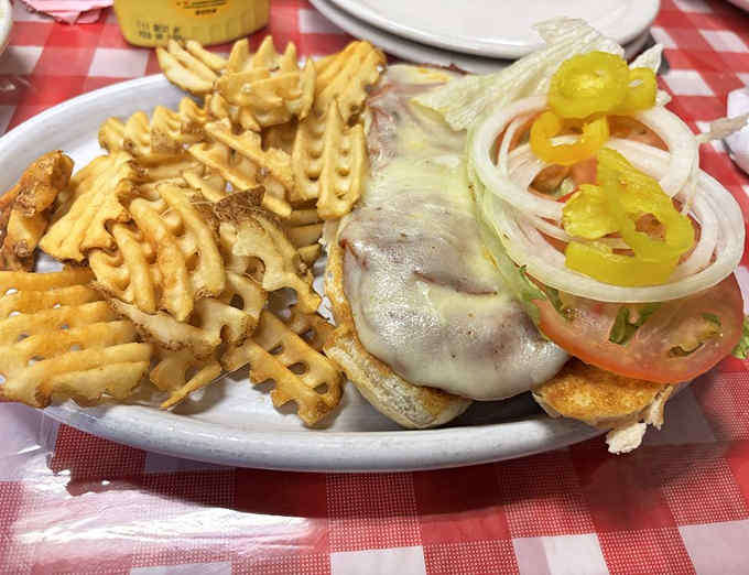 Waffle fries and an Italian sub that means business &ndash; crispy, golden potatoes beside a sandwich stacked with fresh toppings.