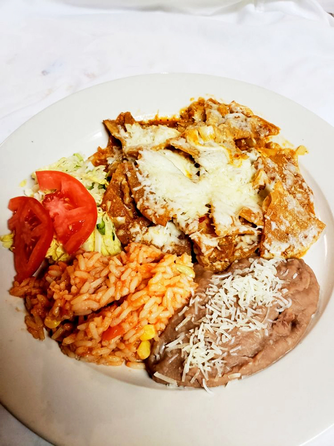 A fiesta for your taste buds! Crispy tortillas bathed in zesty sauce, topped with eggs and cheese &ndash; it's how mornings were meant to begin.