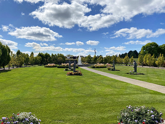 Formal gardens create pathways to discovery, where fountains dance and perfectly trimmed hedges frame views that change with each Michigan season.