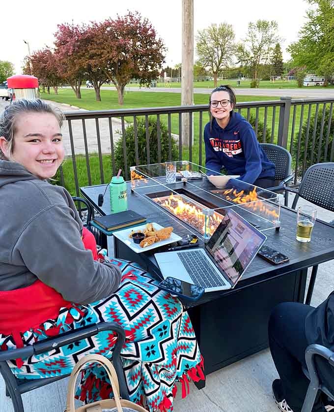 Patio dining with fire features means the outdoor season extends beyond summer, letting you enjoy fresh air with your pizza.
