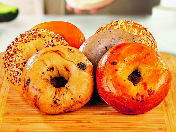 A rainbow of bagel varieties awaits your selection – from classic plain to everything-coated flavor bombs ready for toasting.