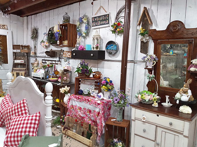 White-washed walls create the perfect backdrop for this bedroom vignette where vintage linens and floral arrangements invite you to dream of simpler times.