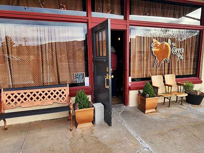 The Copper Pig's entrance exudes rustic charm with its wooden accents and intimate setting, promising a dining experience that feels more like a friend's dinner party.