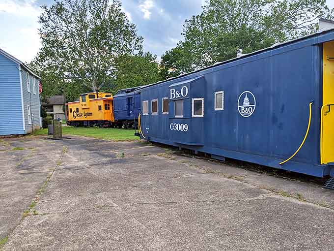 The bold blue B&O caboose stands in striking contrast to its yellow Chessie companion, showcasing railroad history in living color.