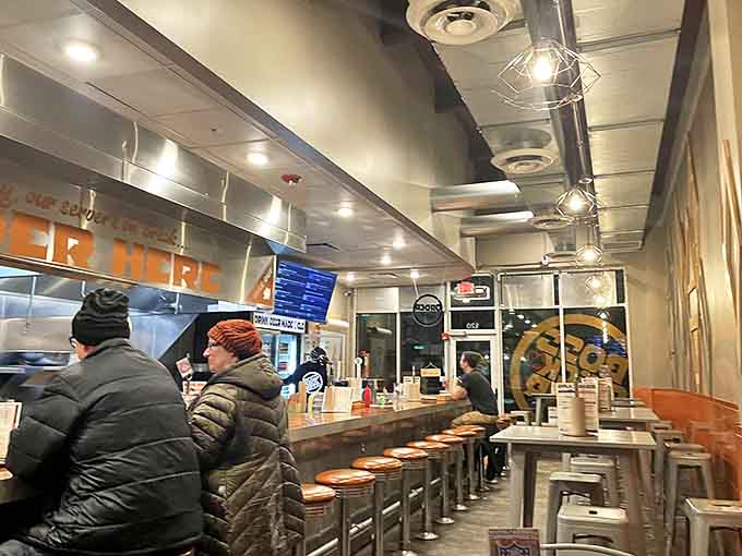 Hungry patrons line the counter, patiently waiting for their flavor fix while the kitchen hums with activity in this beloved local hotspot.