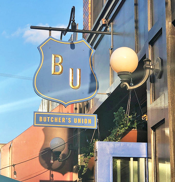 Look for the shield! Our iconic blue and gold sign marks the spot for incredible meat, whiskey, and good times.