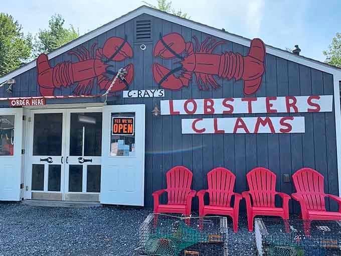 The exterior might be humble, but those bright red Adirondack chairs are practically begging you to sit down and stay awhile.
