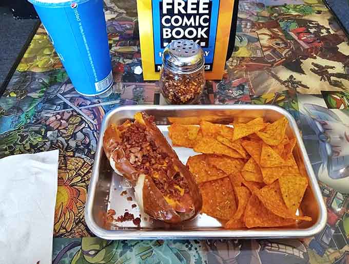 The ultimate comfort food combo: a hearty chili dog paired with crispy nachos, served on a tray showcasing comic book art.