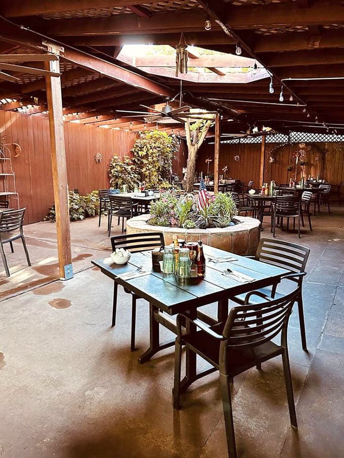 Covered patio seating provides the perfect compromise between indoor comfort and outdoor ambiance, with plants adding natural charm throughout.