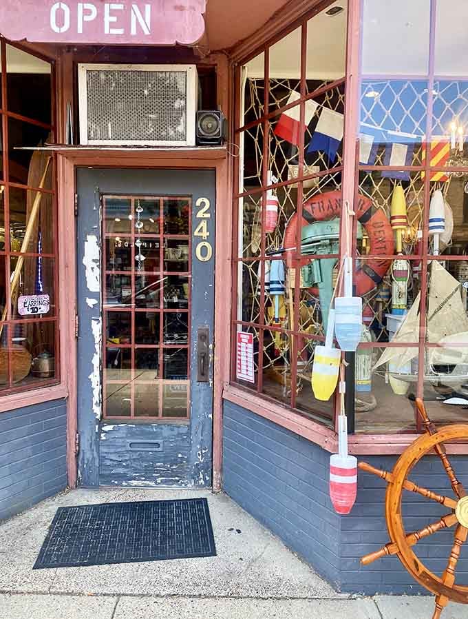 The entrance welcomes visitors with colorful buoys and nautical charm, promising adventures in treasure hunting just beyond that weathered door.