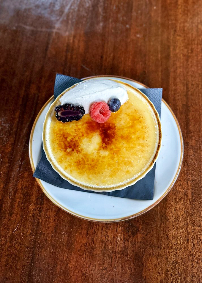 Crack into this creme brulee and discover a velvety custard that's smoother than a jazz saxophone solo. Topped with berries for a burst of freshness.