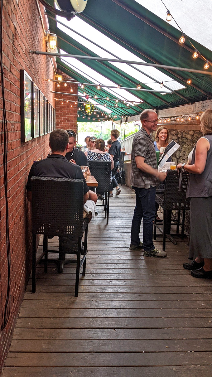 The covered patio creates that perfect indoor-outdoor vibe where summer evenings stretch longer and conversations flow as freely as the drinks.