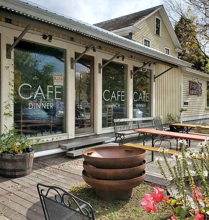 The outdoor patio extends the eclectic charm outside, offering al fresco dining among fire bowls and flowering plants.