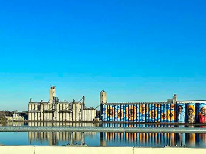 The Glass City River Wall stands in perfect harmony with Toledo's industrial skyline, bridging the city's manufacturing past with its artistic future.