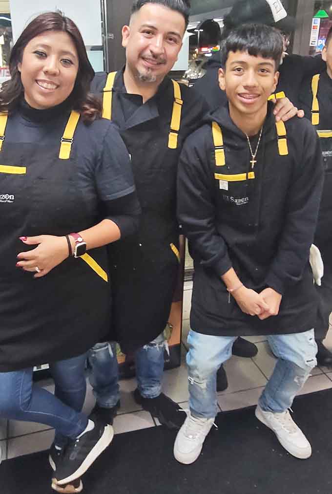 The smiling staff members represent the heart of El Sazon, where warmth and pride in their work shine through in every interaction.