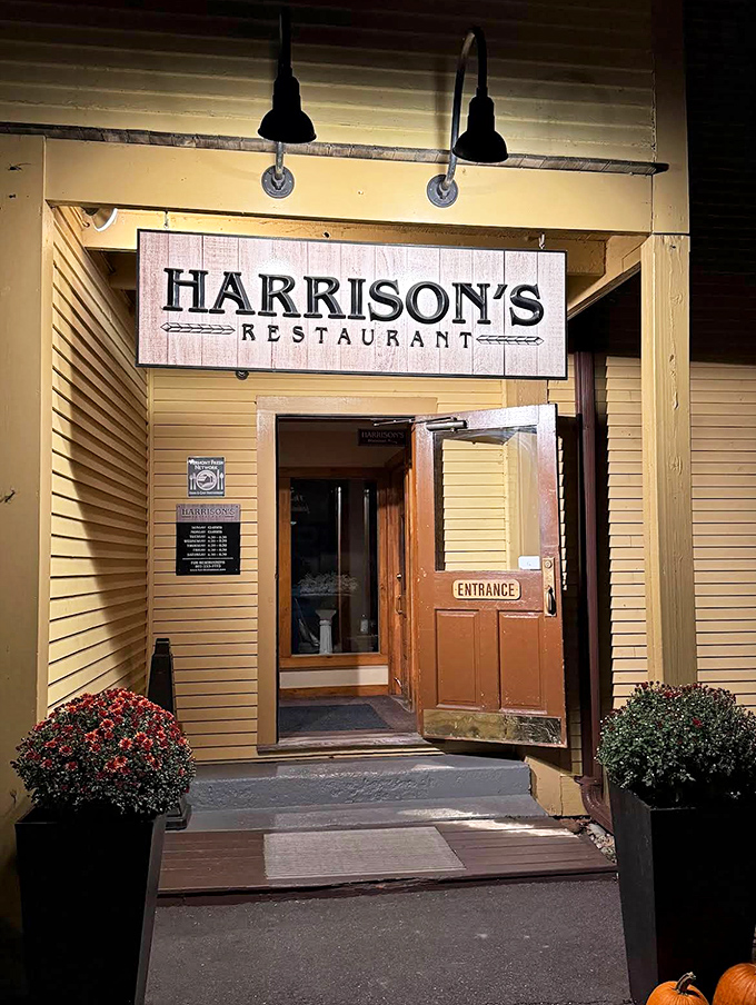 The welcoming doorway to flavor town, flanked by seasonal plants that seem to whisper, "Yes, this is the right decision."