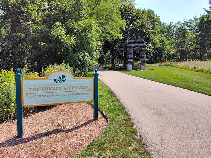 The park's welcoming gateway frames an arched sculpture in the distance, inviting visitors to begin their artistic journey.