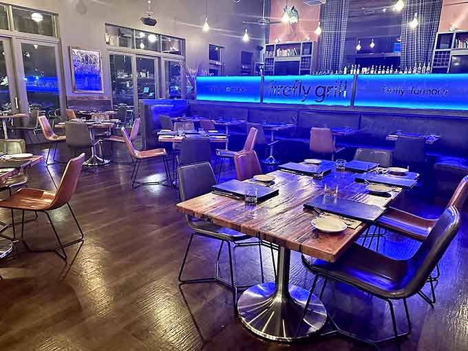Evening ambiance transforms the dining room with moody blue lighting, creating an atmosphere perfect for date night or celebrating life's delicious moments.