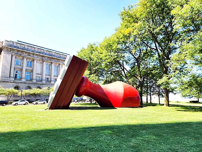 Bathed in golden sunlight, the Free Stamp's vibrant red pops against the green lawn, creating a picture-perfect Cleveland moment.